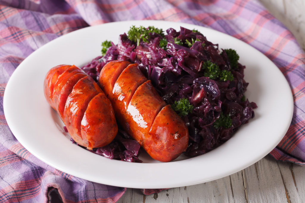 FreshPoint | Sausage grill with stewed red cabbage close-up. horizontal